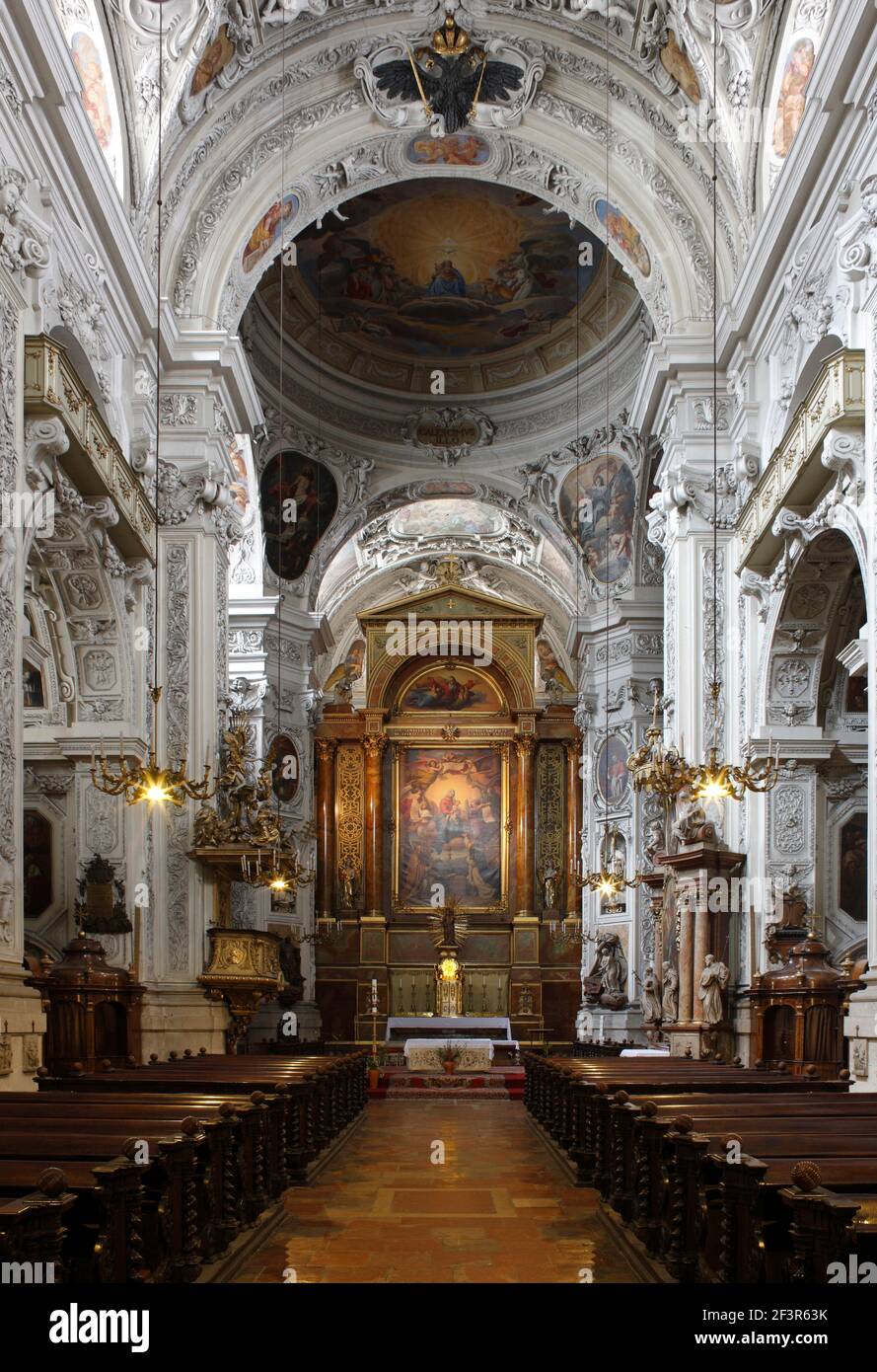 Baroque interior with gold altar sculpture, stucco decorations, fresco ...