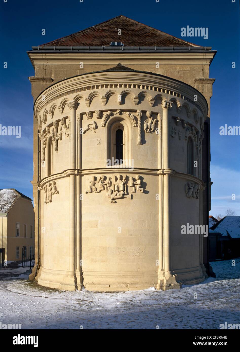 Naive figures in relief on eastern apse of Romanesque parish church ...