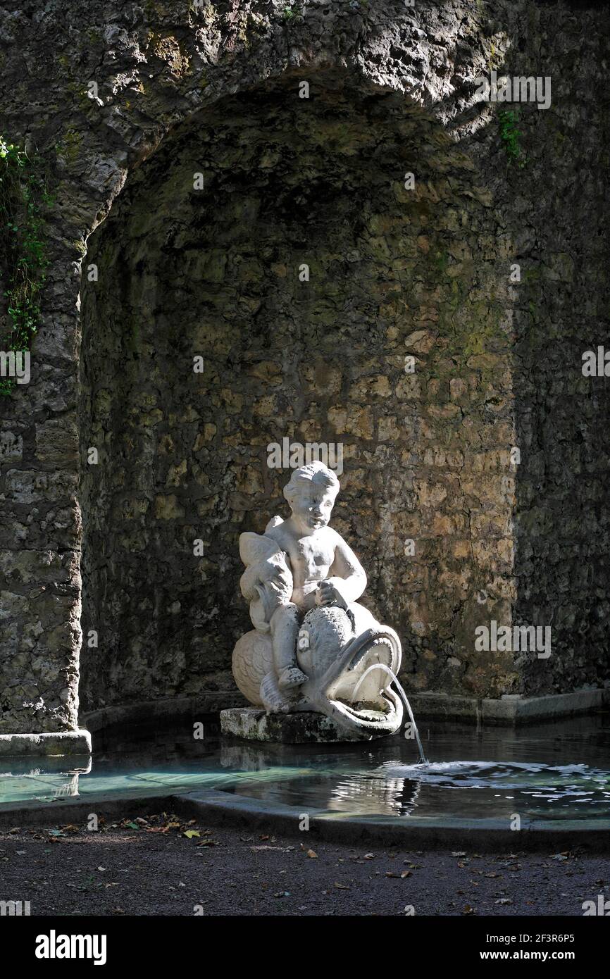 Stone statue boy fish hi-res stock photography and images - Alamy