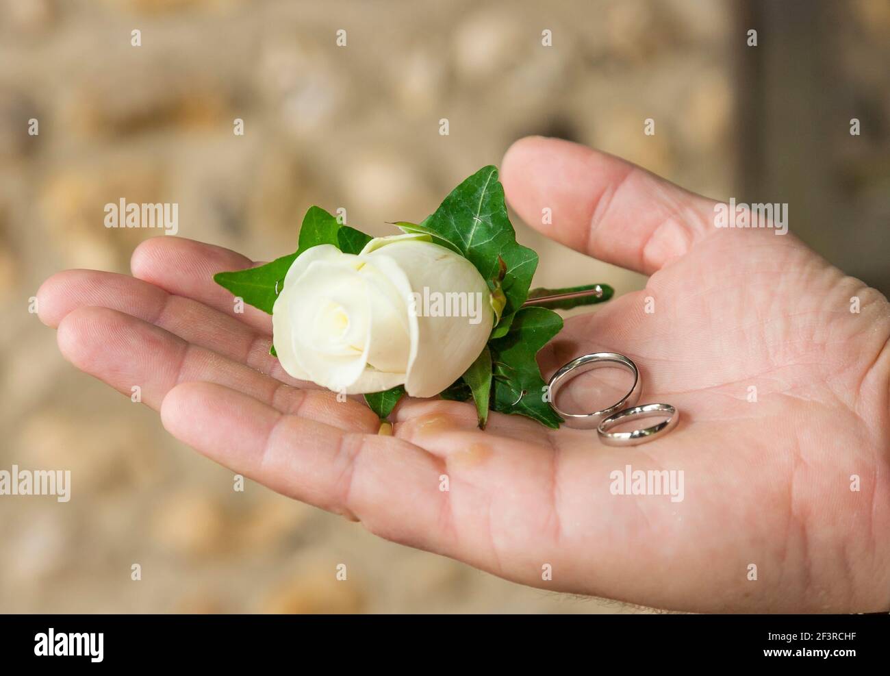 Wedding Ring and Flower on hand Stock Photo - Alamy