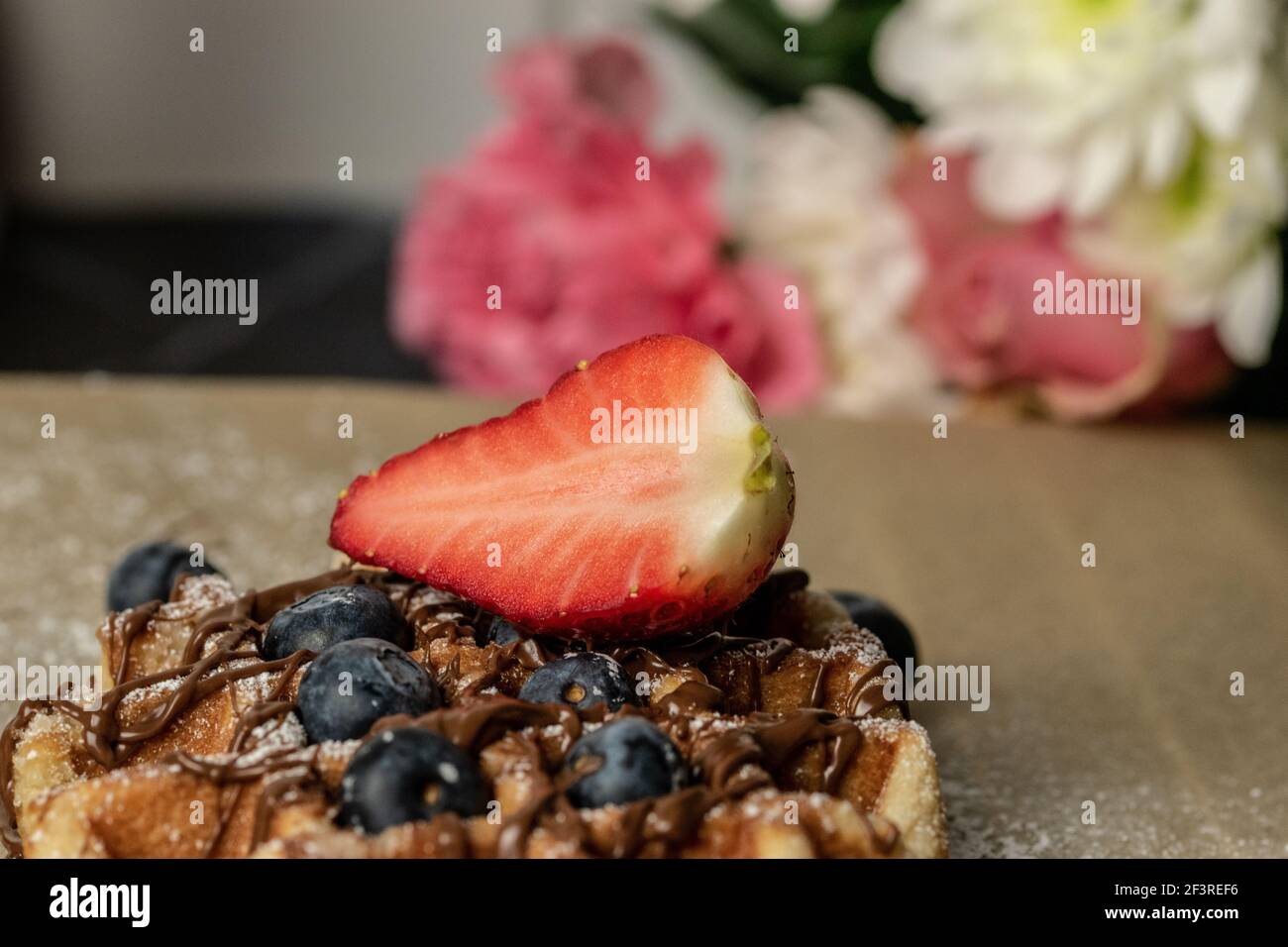 A delicious Belgian waffle decorated with chocolate cream, blueberries ...