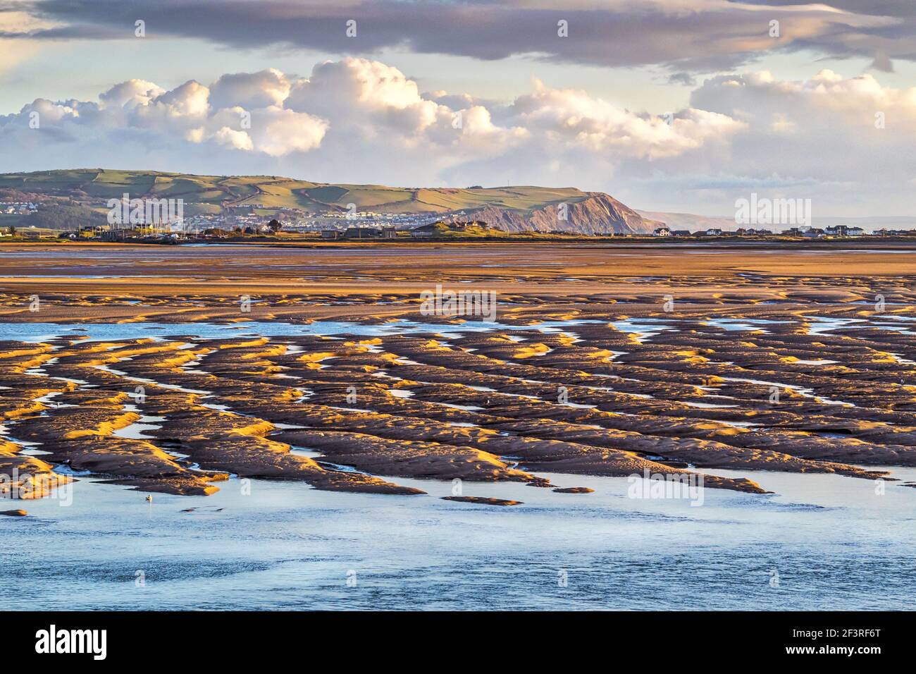 Sand ridges are exposed by the low tide at Aberdovey in West Wales ...
