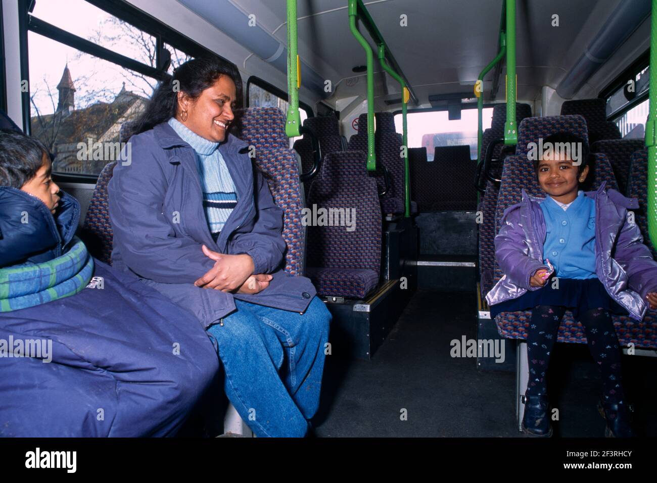 Mother and Children Travelling on a City Bus England Stock Photo - Alamy