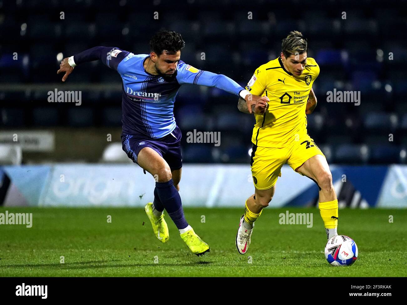 Wycombe Wanderers' Ryan Tafazolli (left) and Barnsley's Dominik Frieser ...