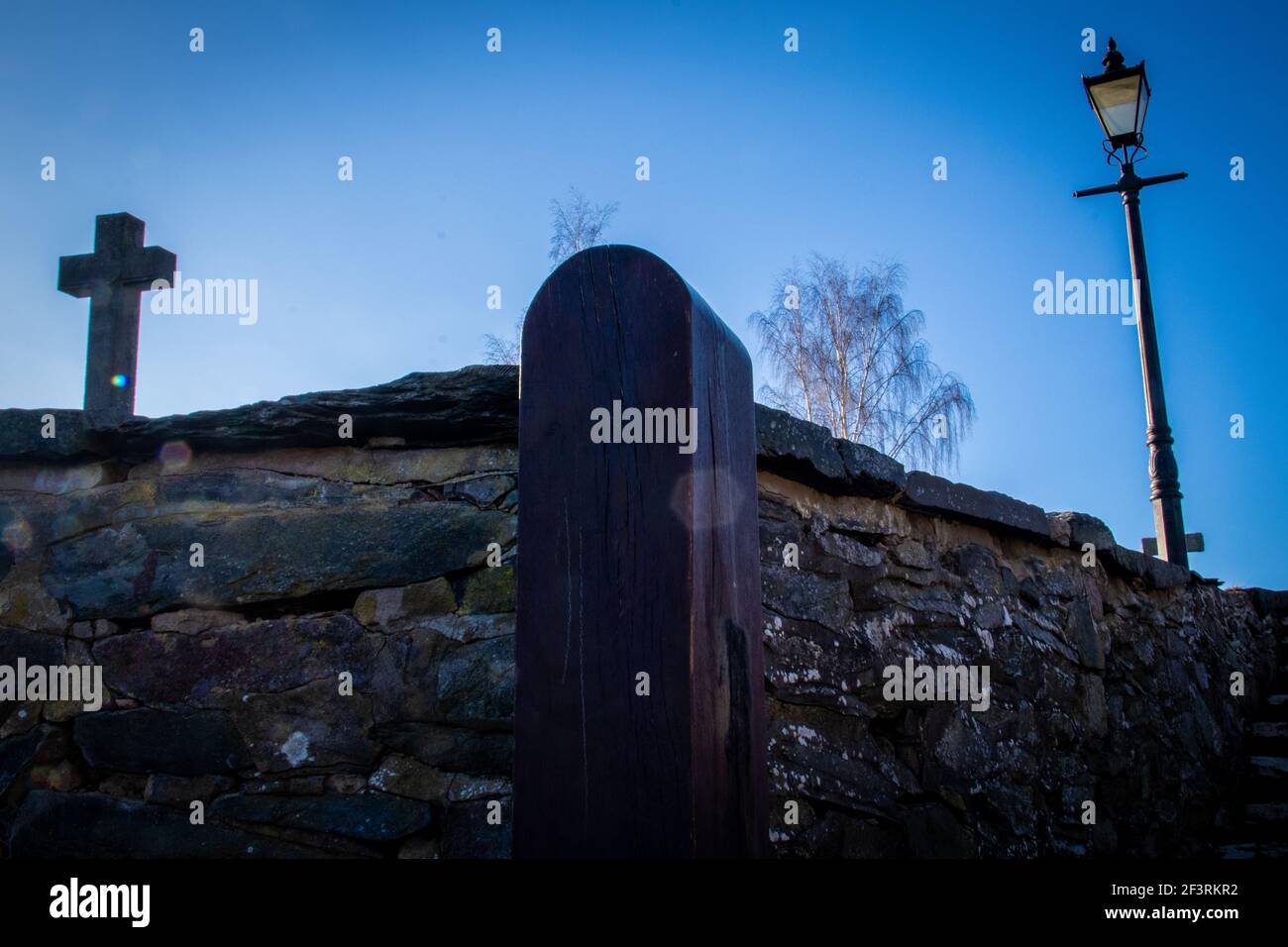 An old grave and streetlamp in the graveyard of Ratby Church, Leicester ...