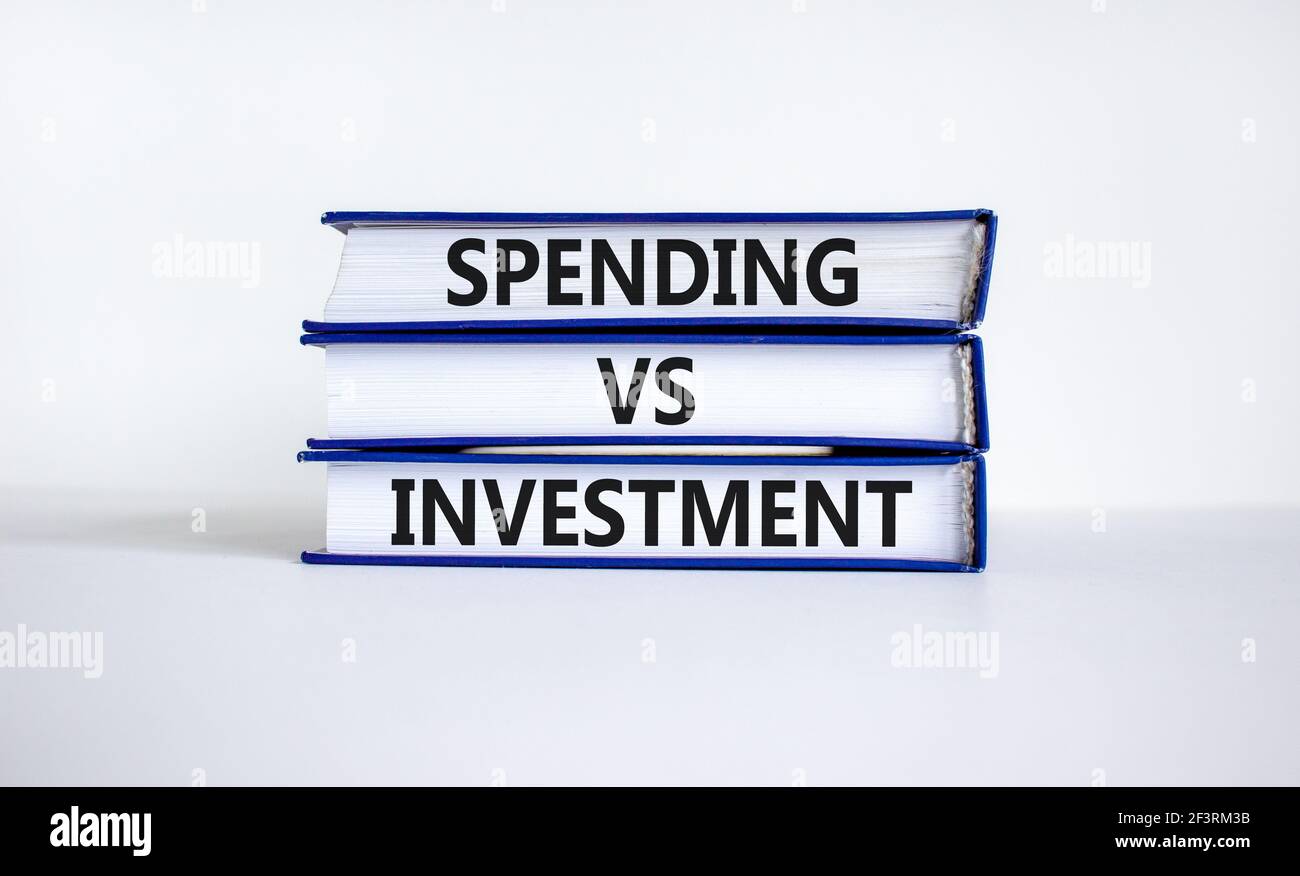 Spending vs investment strategy symbol. Books with words 'Spending vs ...