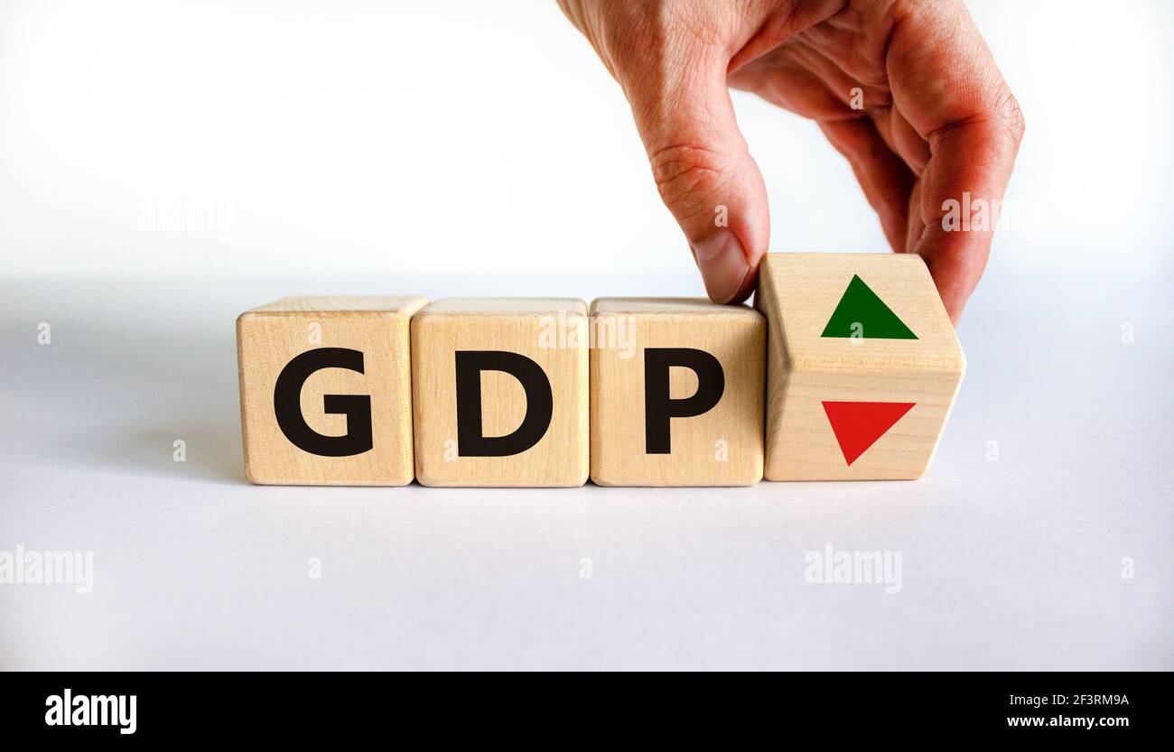 GDP, gross domestic product symbol. Businessman holds a cube with up ...