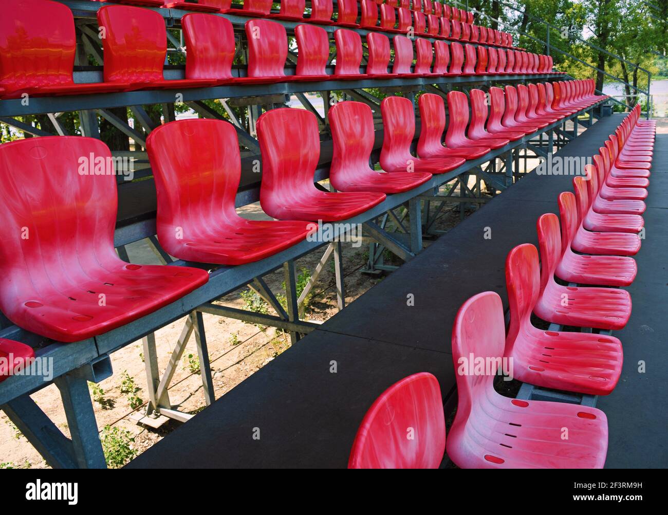 View of the many red seats in the football stadium. Sports activities ...