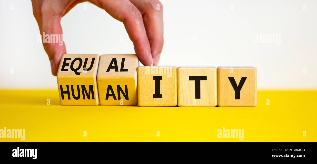 Equality and humanity symbol. Businessman turns wooden cubes and ...