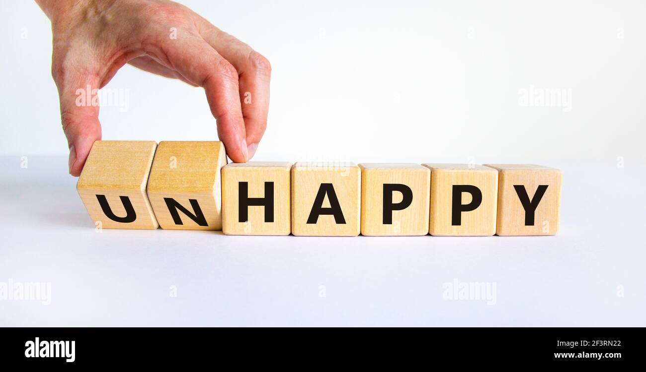 Be happy, do not unhappy symbol. Businessman turns wooden cubes and ...