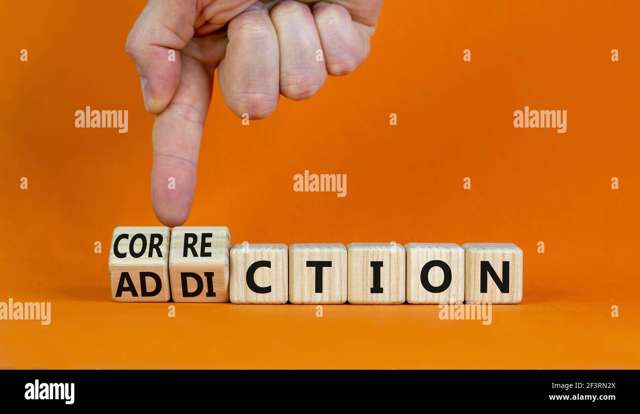 Correction addiction symbol. Businessman turns wooden cubes and changes ...