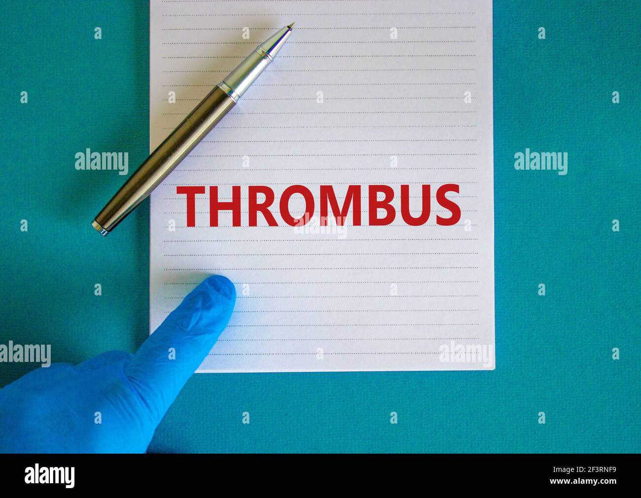 Medical and thrombus symbol. Doctor hand, metalic pen. White note with ...