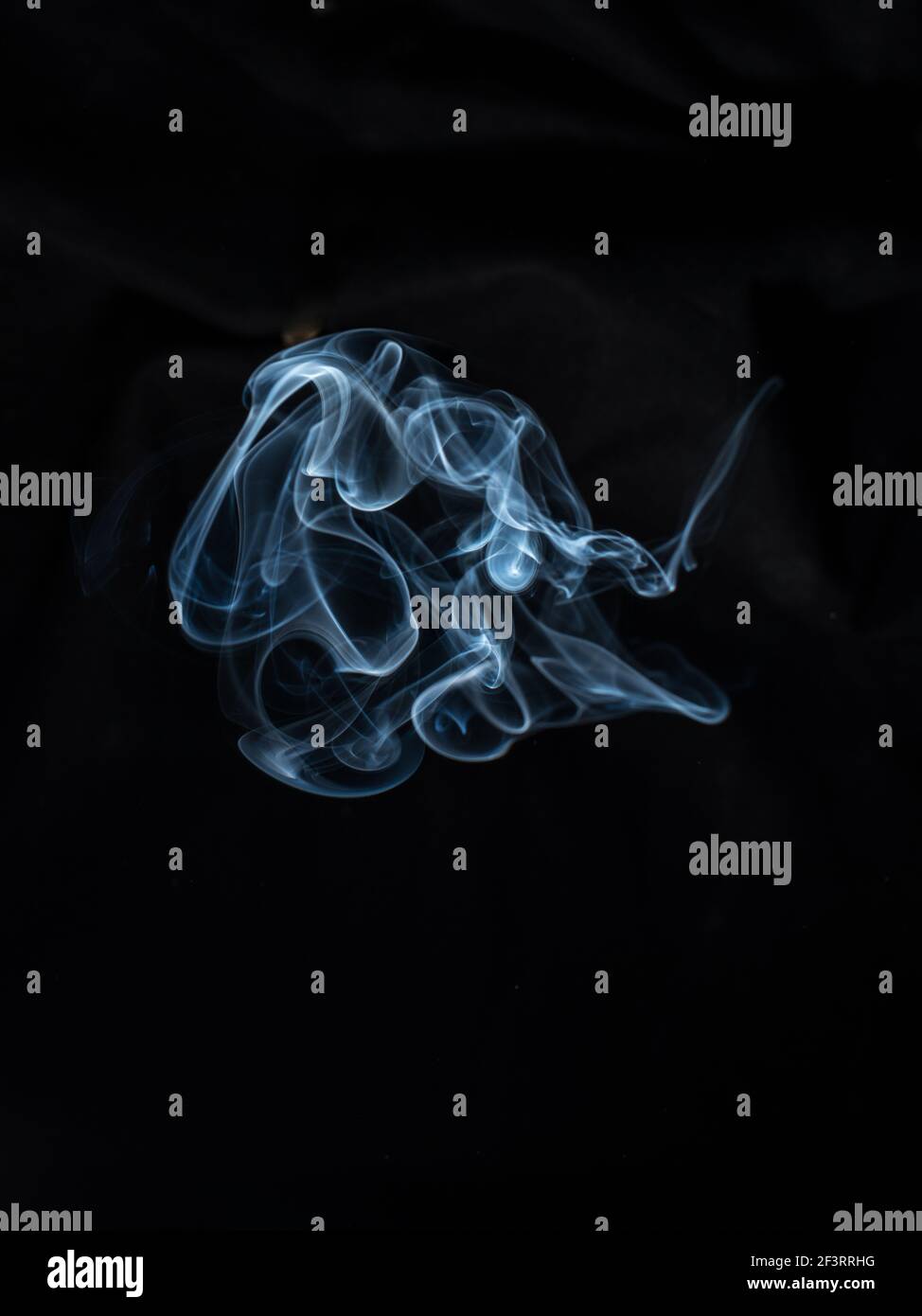 Blue smoke on black background Stock Photo - Alamy