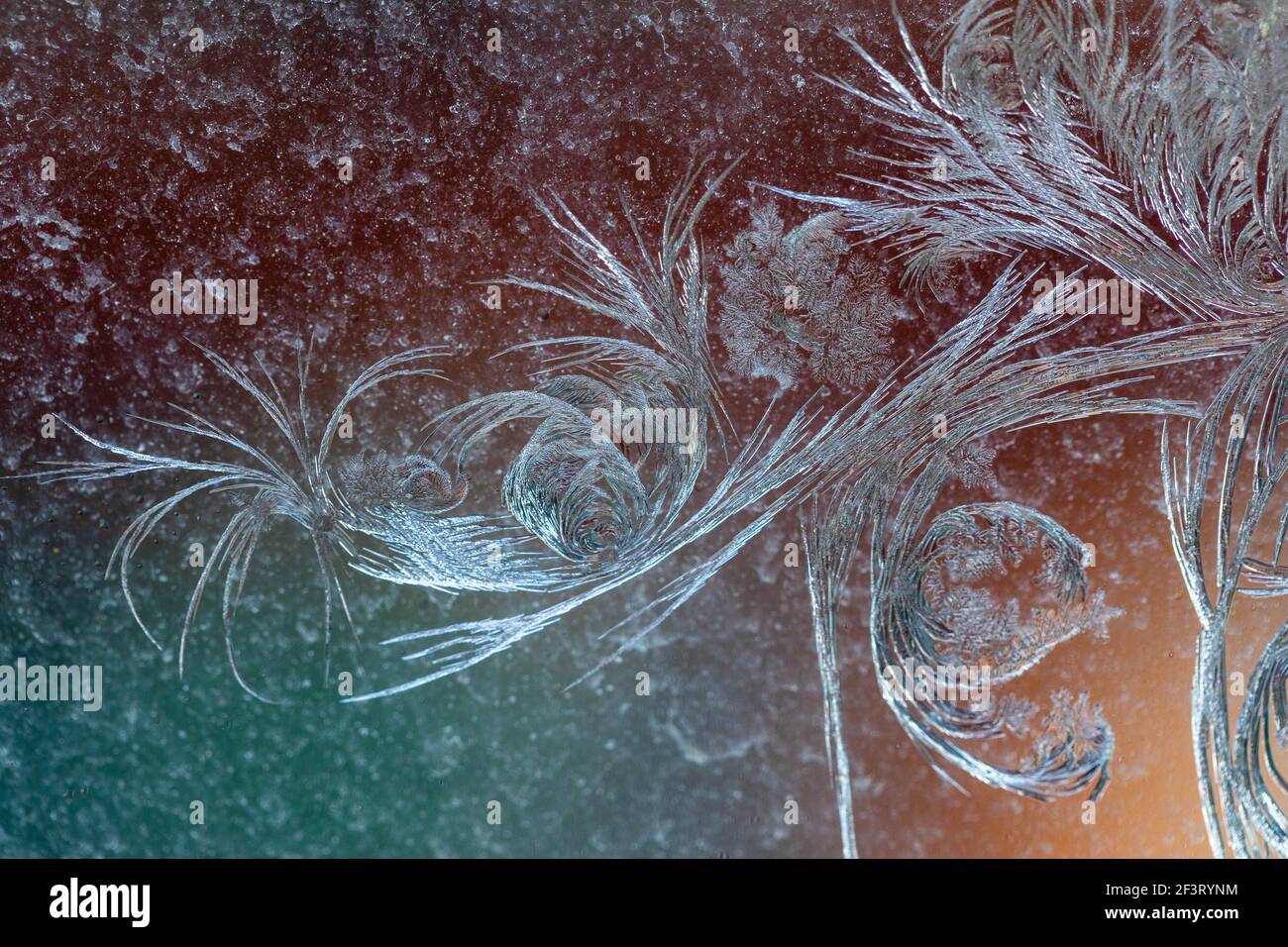 Jack Frost etchings on the window, with a colourful background Stock ...