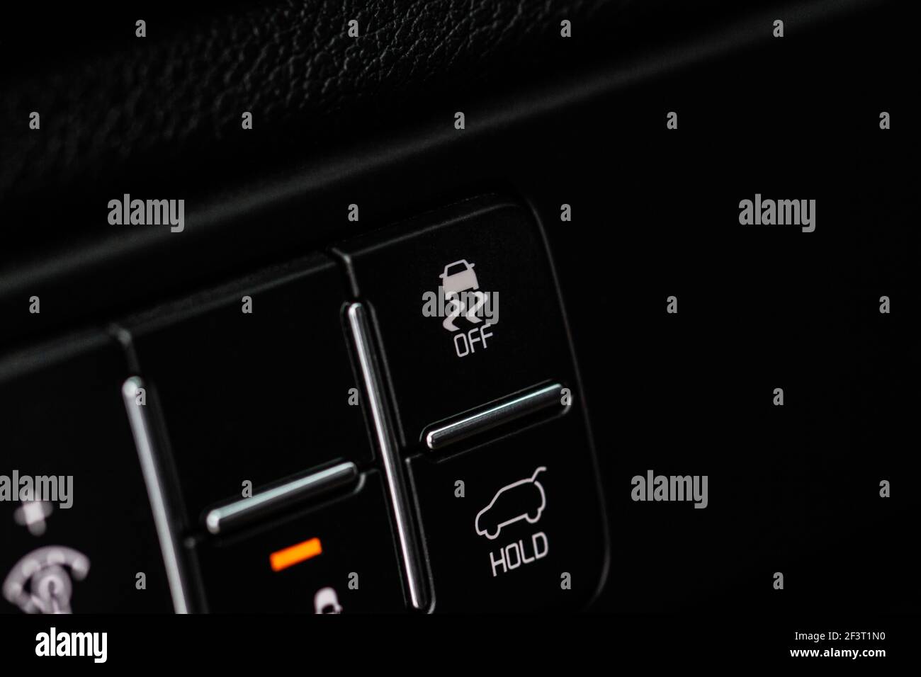 Hand operating ESP (electronic stability program) control close up view ...