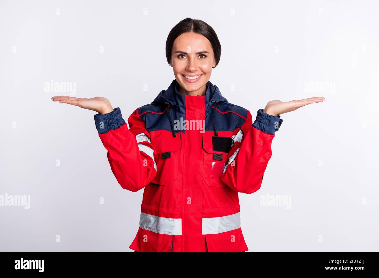 Photo of young woman paramedic happy positive smile hold hands advert ...
