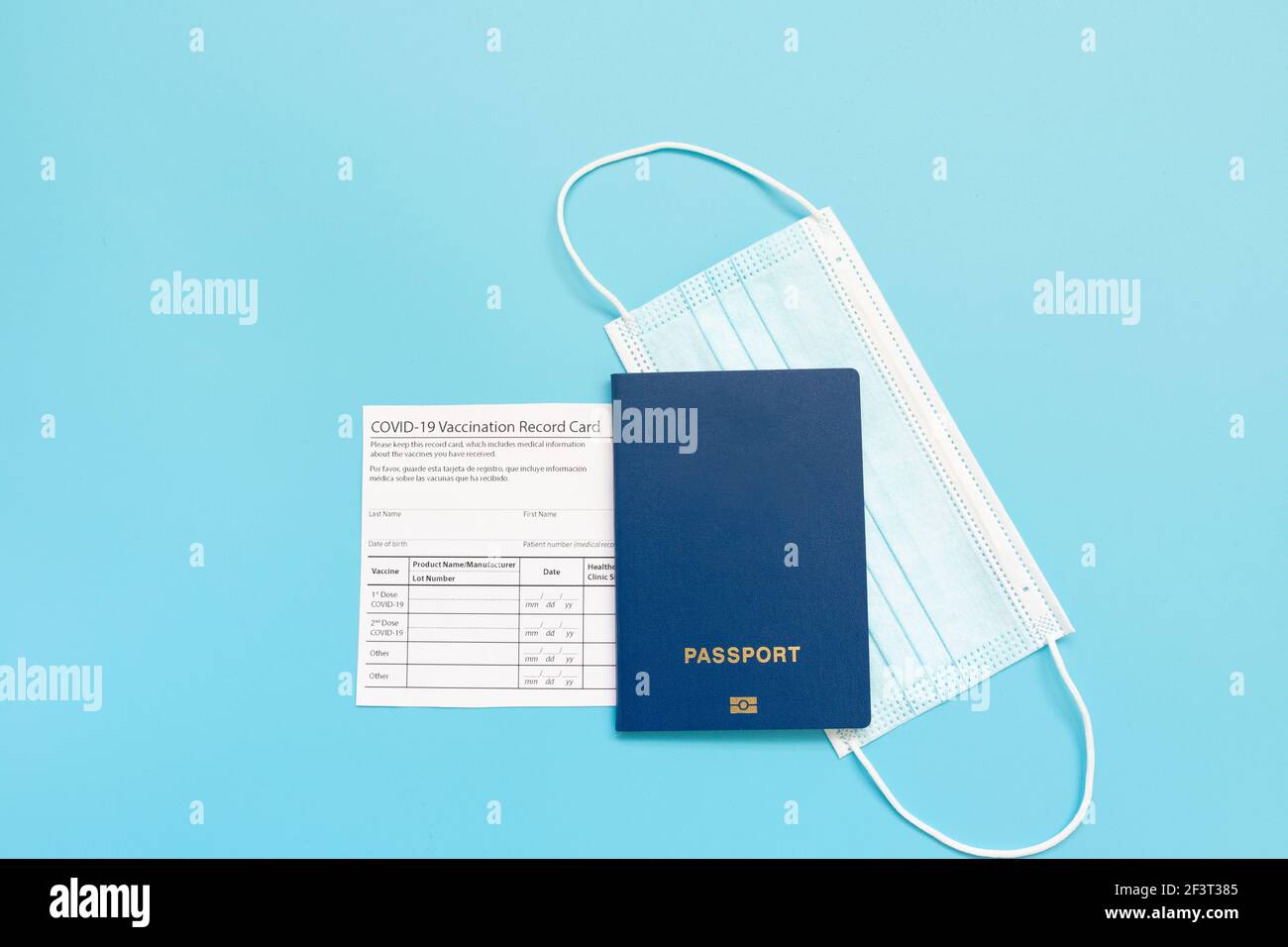 Vaccination record card, passport, a vial with covid-19 vaccine ...