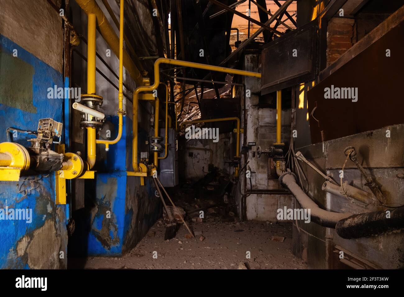 Inside old collapsed industrial building. Old rusty pipeline Stock ...