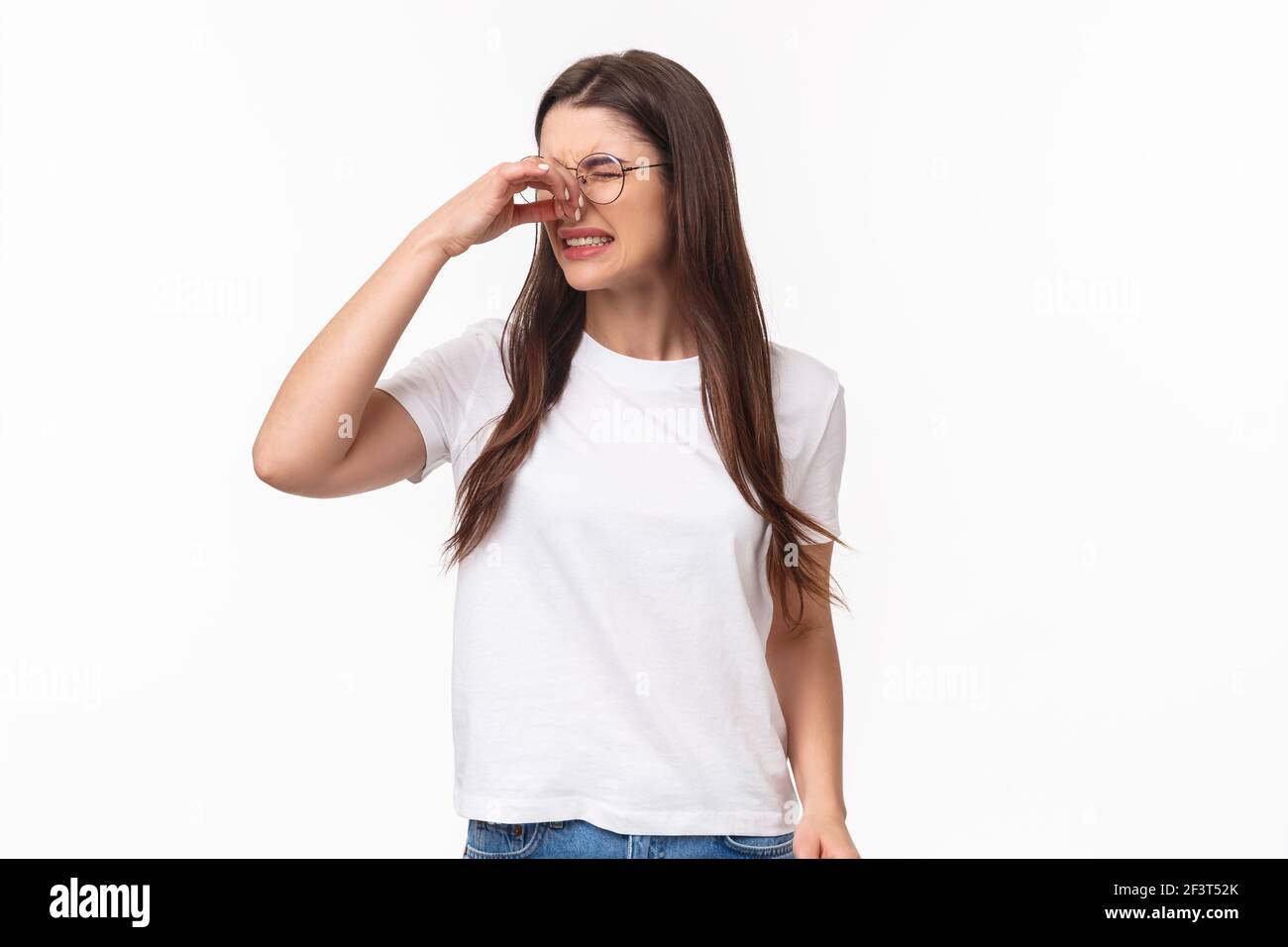 Smells disgusting. Portrait of disgusted and displeased young beautiful ...