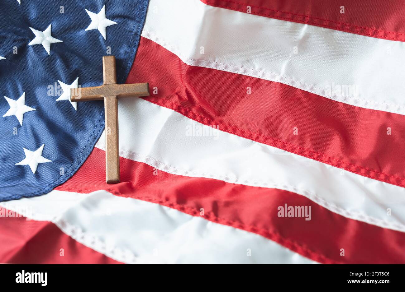 Religious right concept with Christian Wooden cross on American flag ...