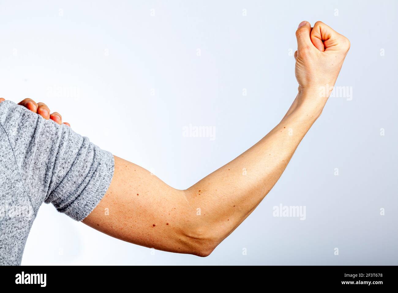a woman is showing her fist and muscles of her forearm and arm in ...