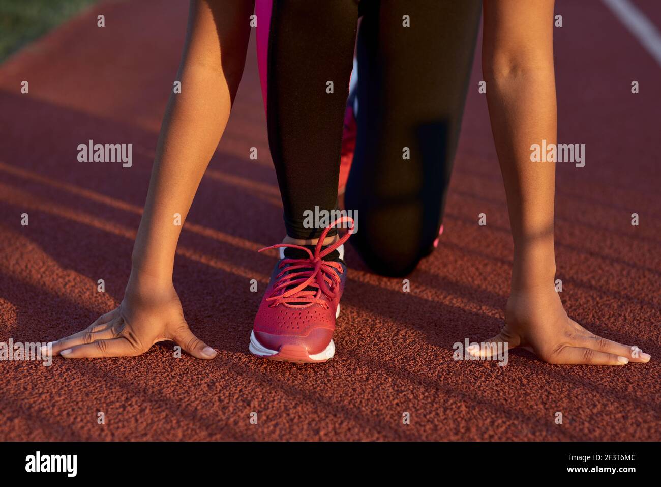 Little girl runner standing in start position before the sprint Stock ...