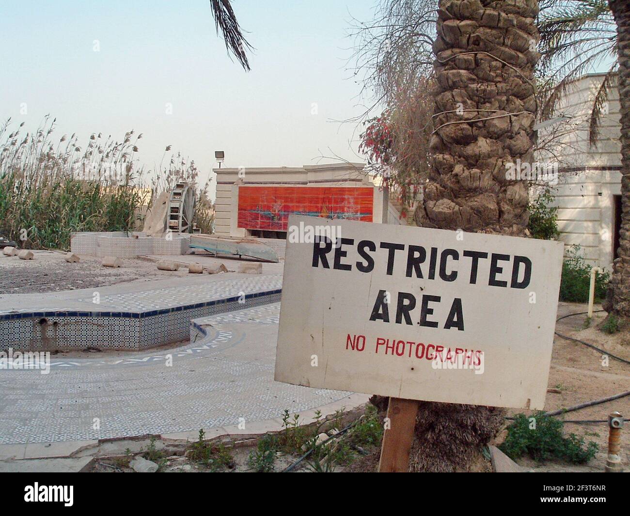 Restricted area sign in front of a Sadaam era building on Camp Slayer ...