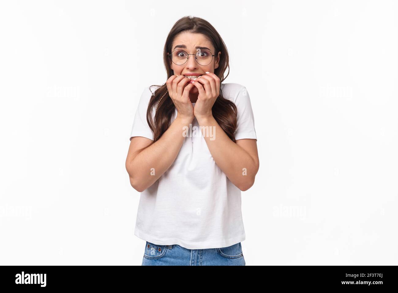 Waist-up portrait of scared young brunette girl in panic, exams are ...