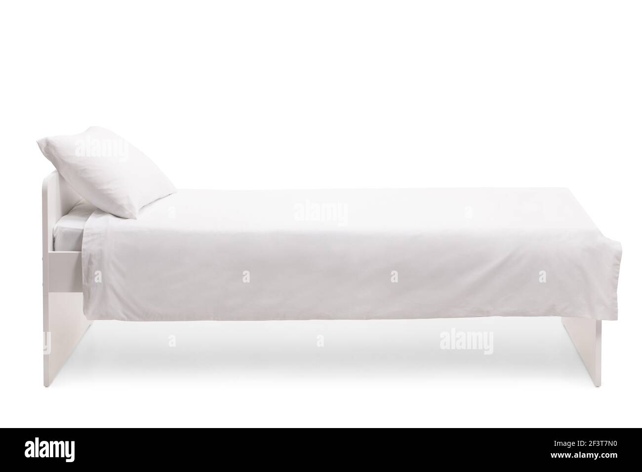 Studio side shot of a white single bed with duvet isolated on white ...