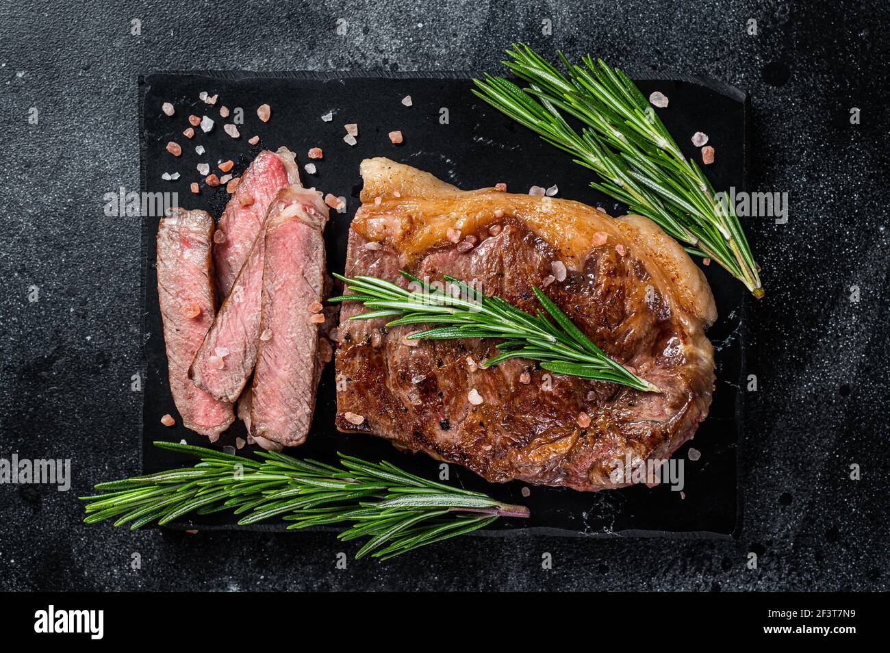 Cut roasted new york strip beef meat steak or striploin on a marble ...