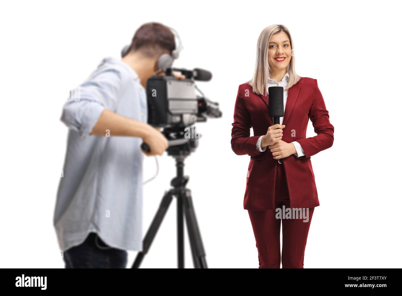 Cameraman recording a female reporter with a microphone isolated on ...