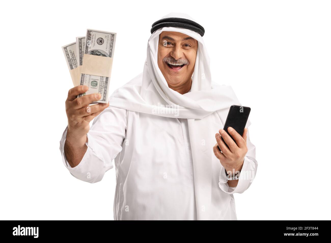 Mature arab man smiling and holding money and a mobile phone isolated ...