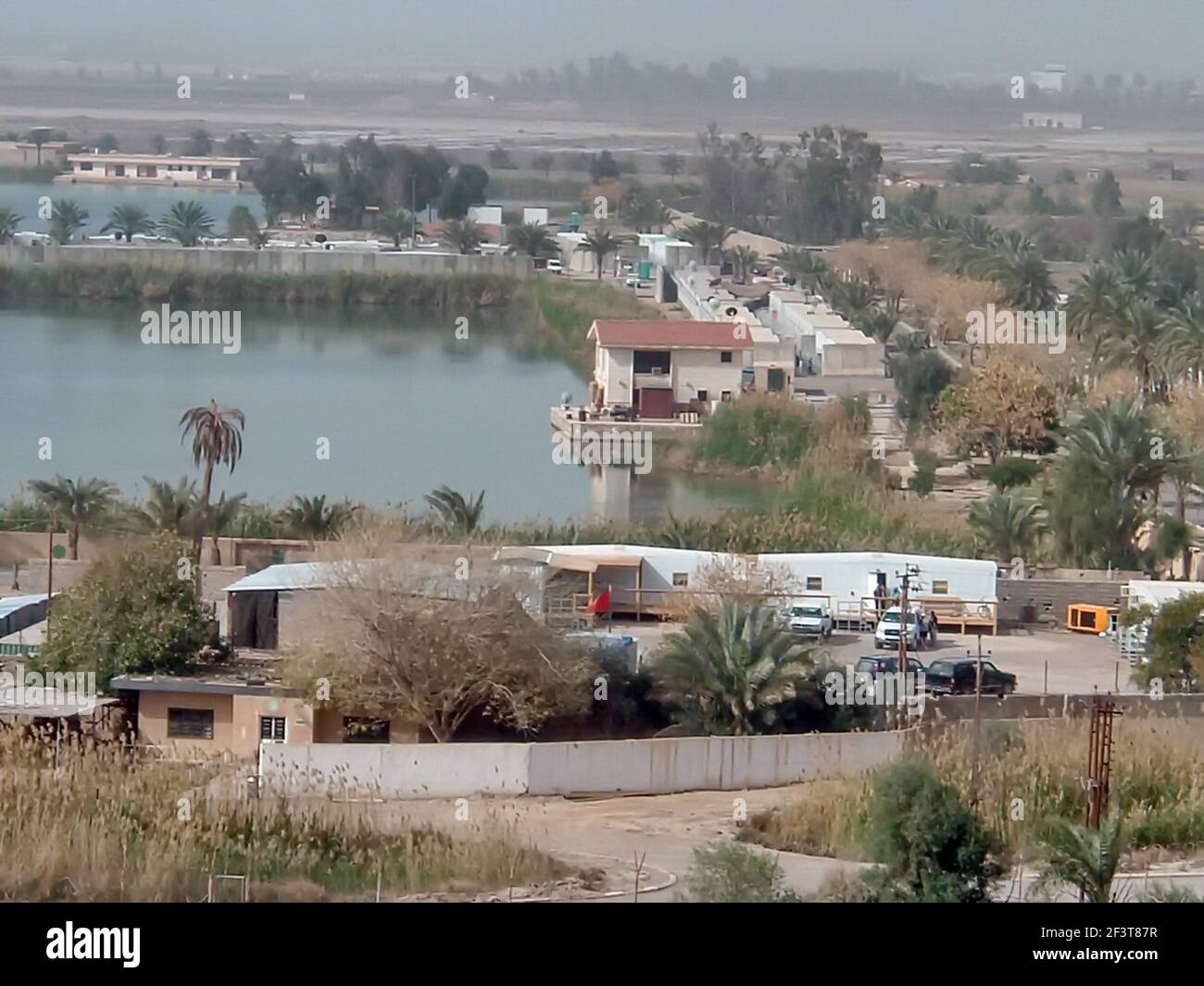 Overhead view of buildings around a lake in Baghdad, Iraq, during the ...