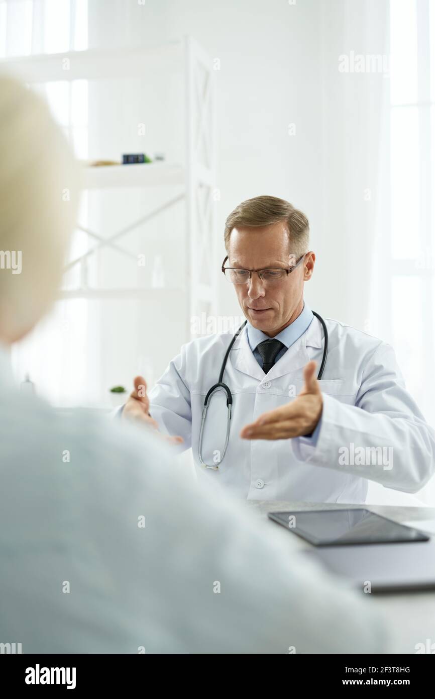 Confused male doctor having appointment with patient in clinic Stock ...