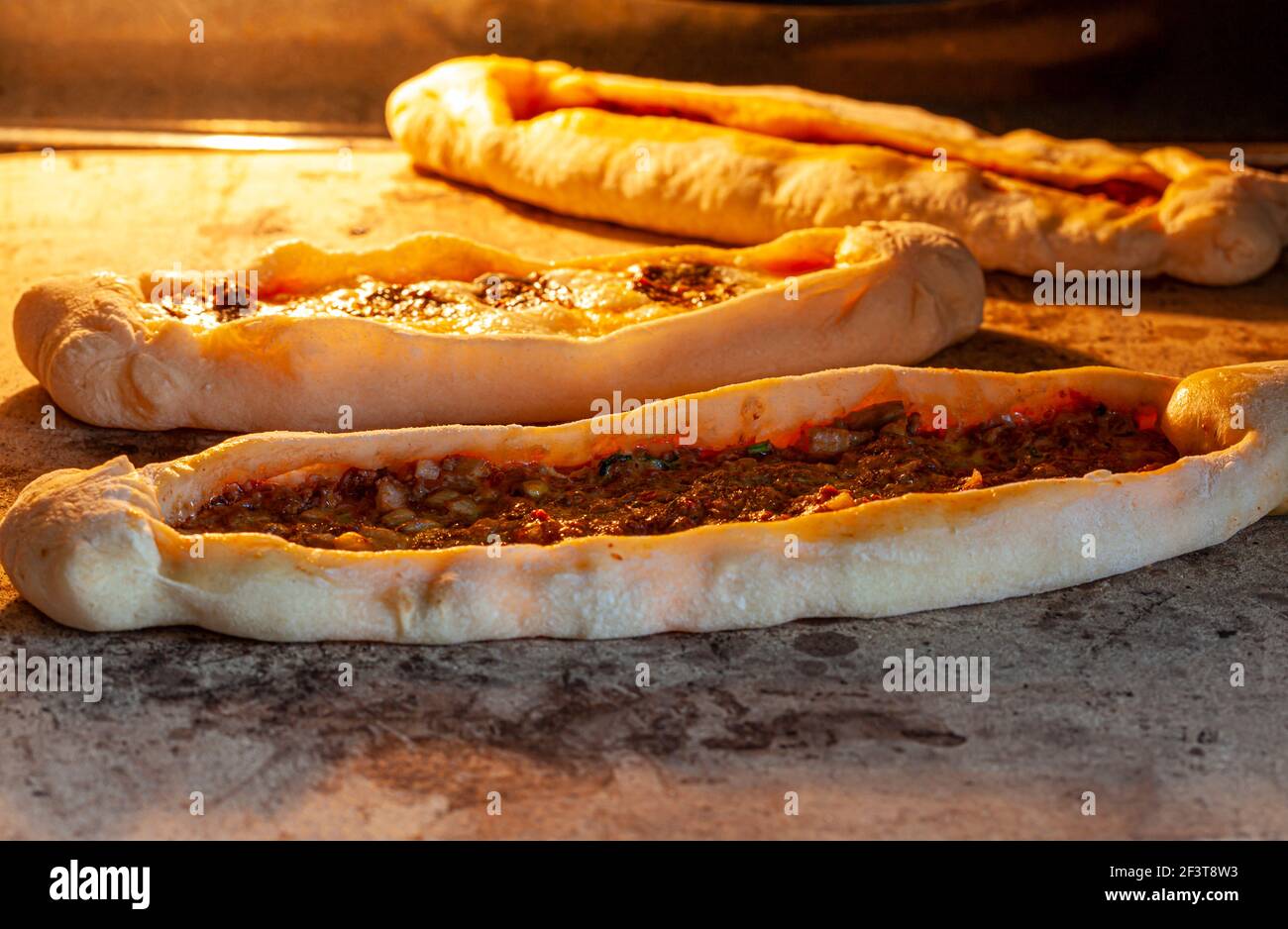 Traditional Turkish flatbreads known as kasarli sucuklu pide and ...