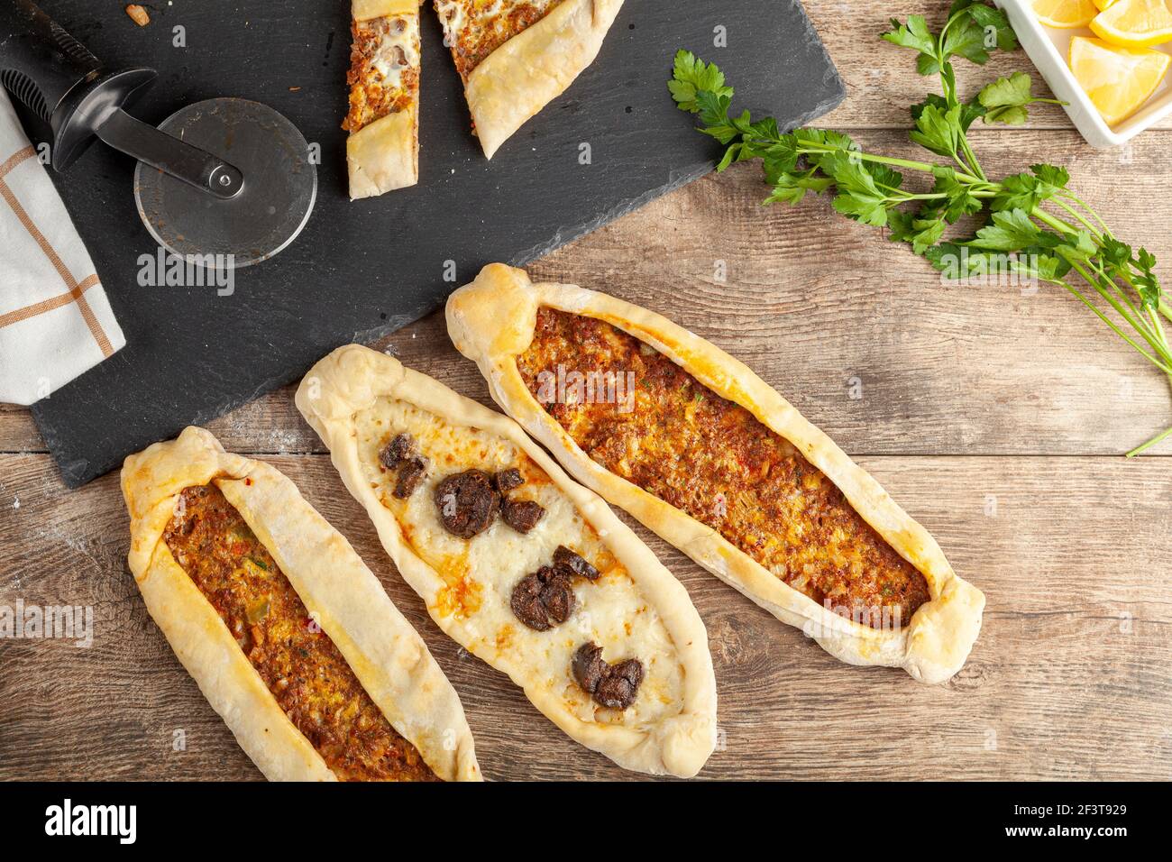 Closeup top view image of Kasarli sucuklu pide and kiymali pide. These ...