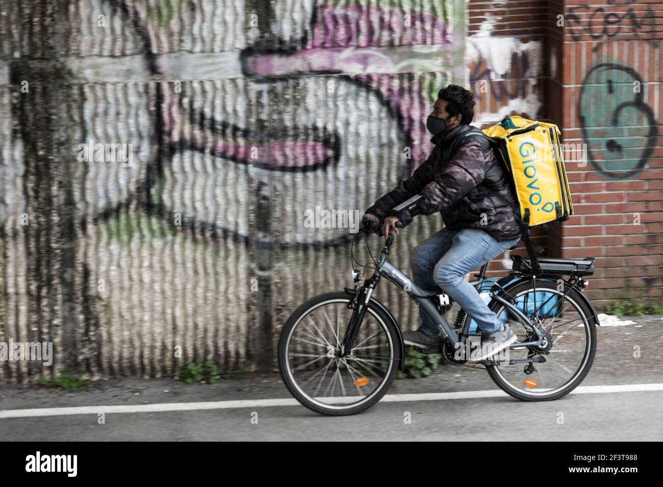 Food delivery rider on electric bicycle Stock Photo - Alamy