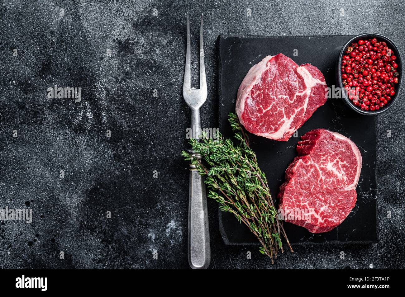 Prime Raw Fillet Mignon tenderloin steaks with thyme. Black background ...