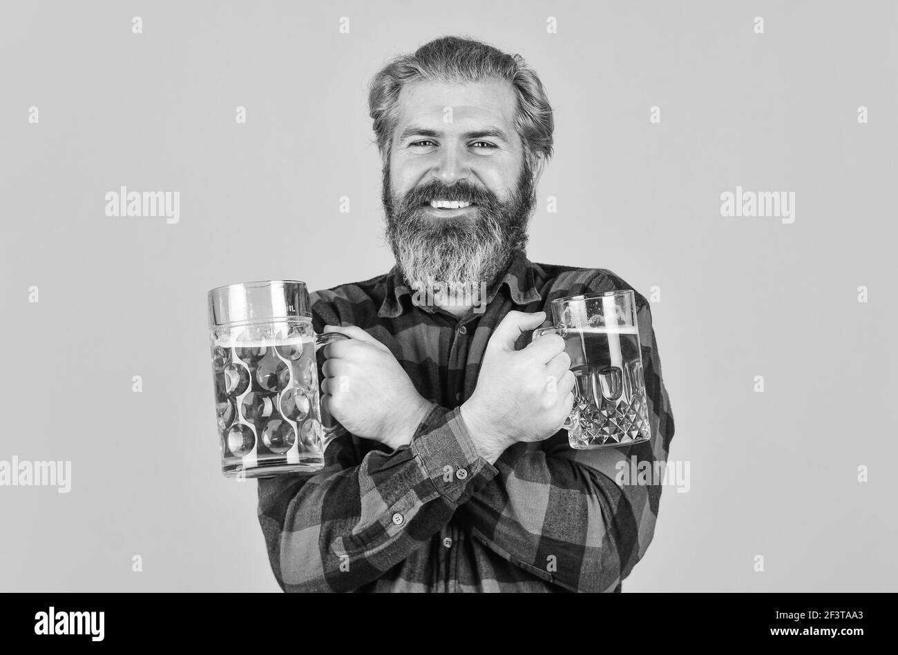 Hipster drink beer. Mature bearded guy hold beer glass. Cheers toast ...