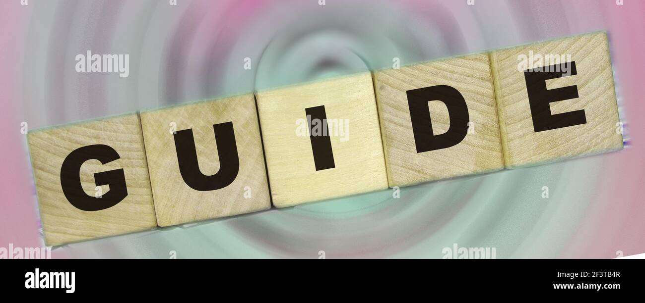 Guide Word Written In Wooden Cubes on relaxed beach landscape ...