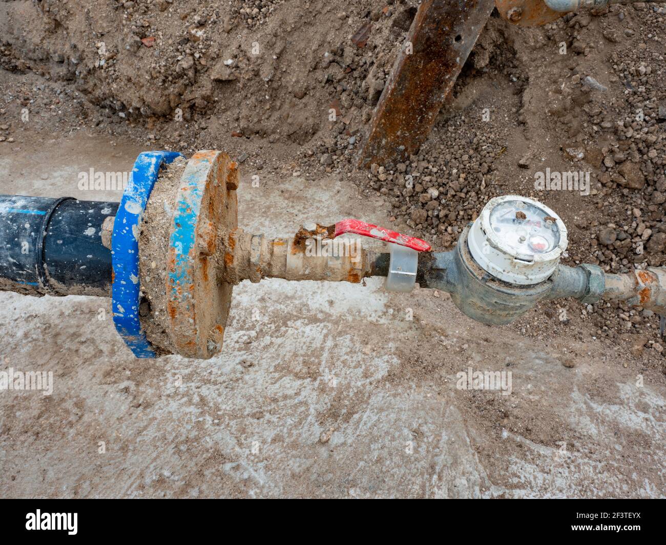 Water consumption meter. Potable water pipes joined with rusty flanges ...