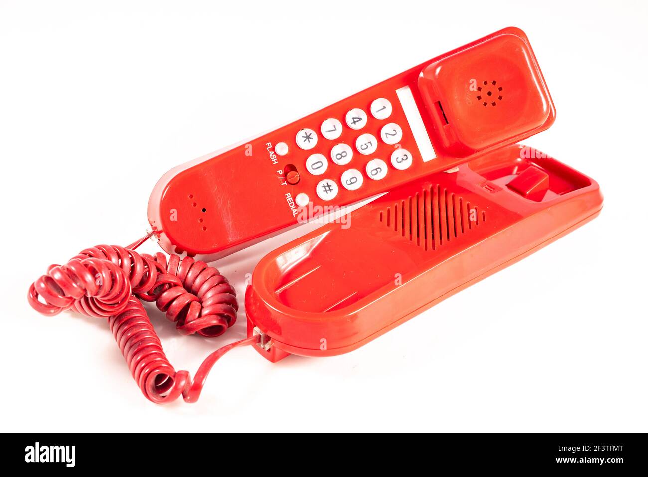 Red analog telephone for making calls. Old electronic accessories used ...