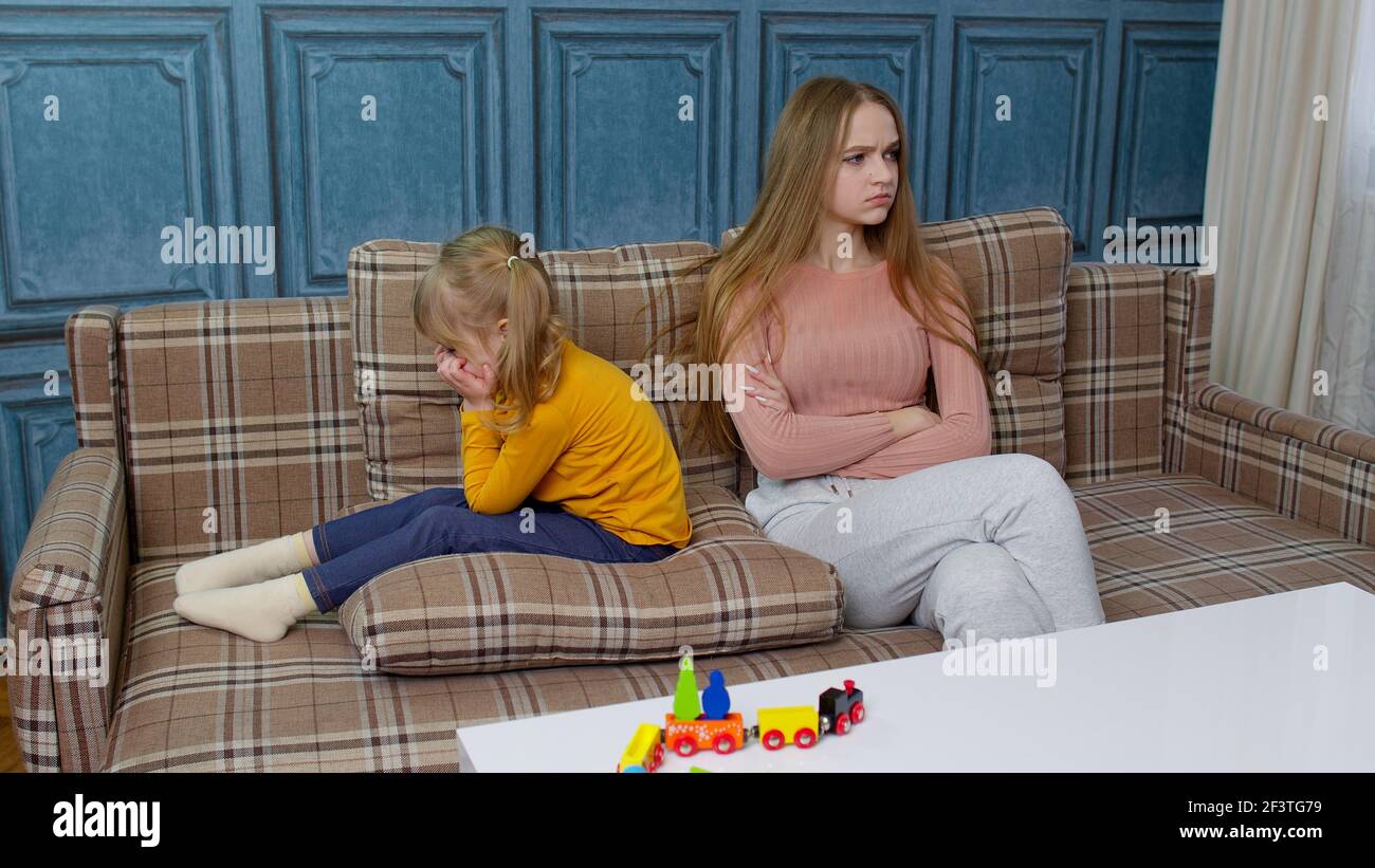 Unhappy stressed woman and angry child girl sister ignoring each other ...