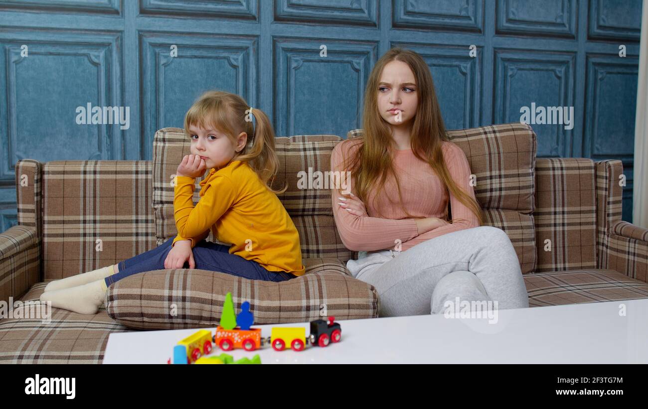 Unhappy mother and stubborn little child daughter ignoring each other ...