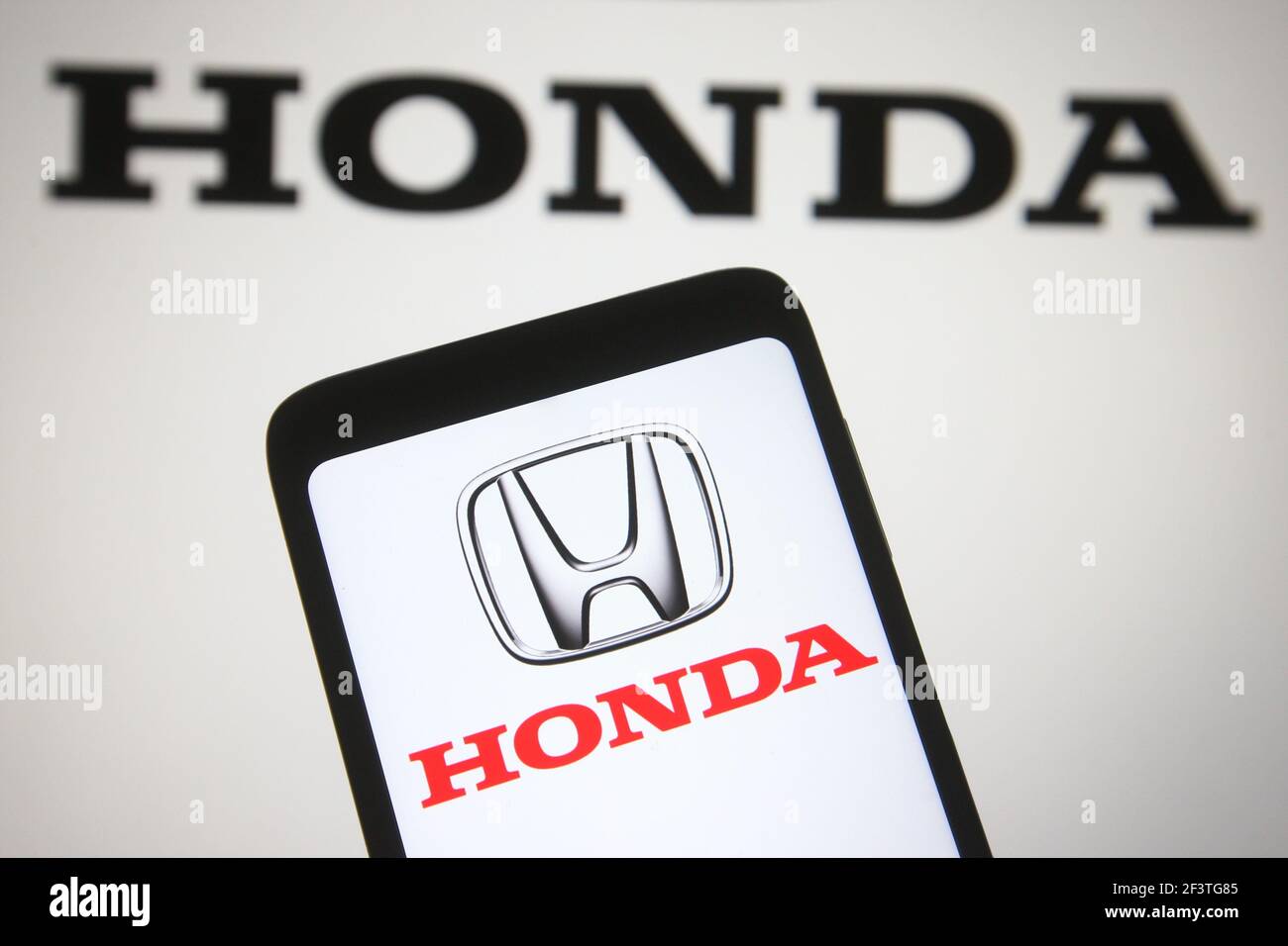 In this photo illustration a Honda logo is seen on a smartphone screen ...