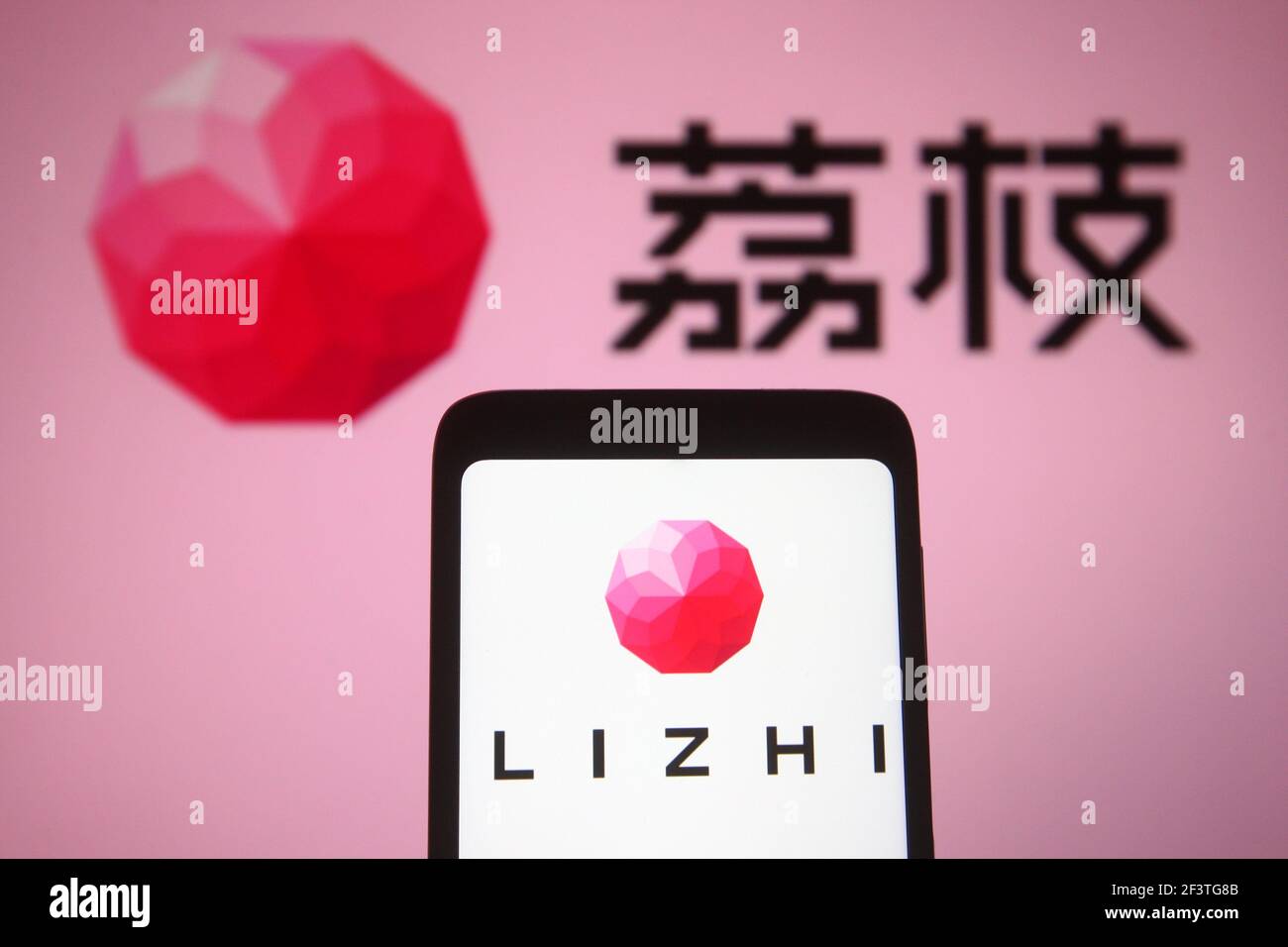 In this photo illustration a LIZHI logo is seen on a smartphone and a ...