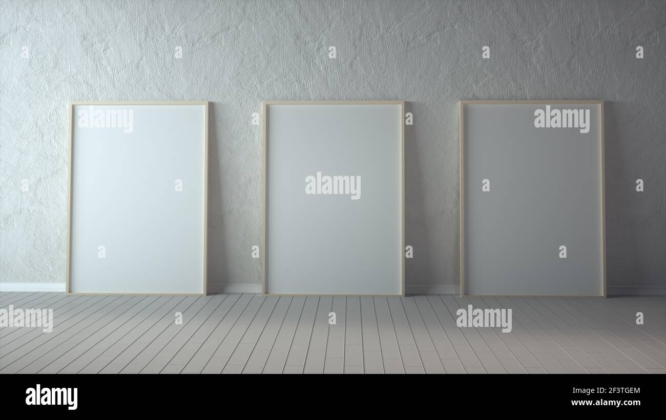 Three vertical wooden frame poster on wooden floor with white wall. 3 ...