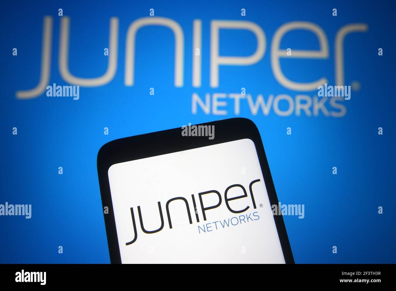 In this photo illustration a Juniper Networks logo is seen on a ...