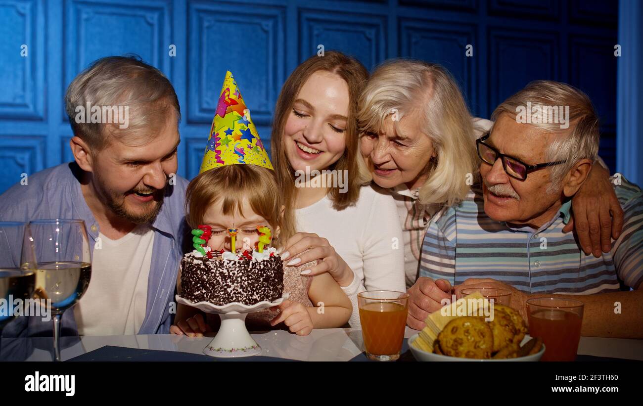 Adorable child girl kid eating cake making wish, having fun ...