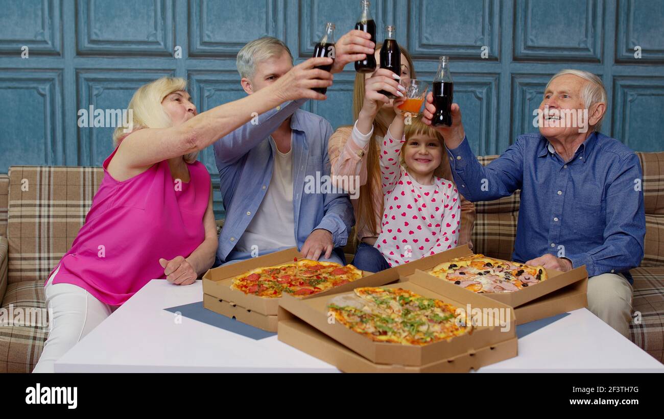 Multigenerational family having lunch party, eating pizza food ...